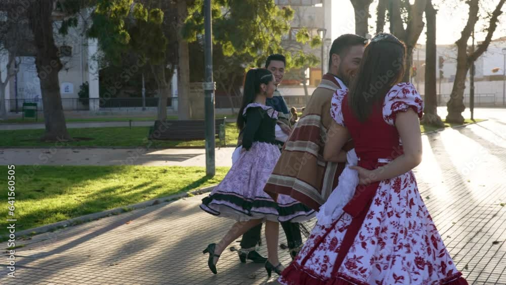 men in huaso costumes lead the women by the arm to dance the cueca in ...