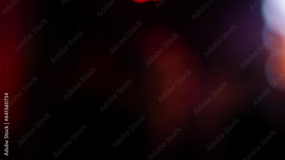 Out of focus video of a concert with the silhouette of people enjoying ...