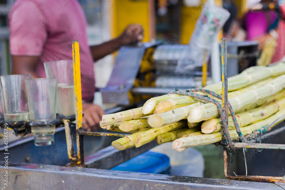 Sugarcane juice stall at roadside for selling sweet juice during hoy ...