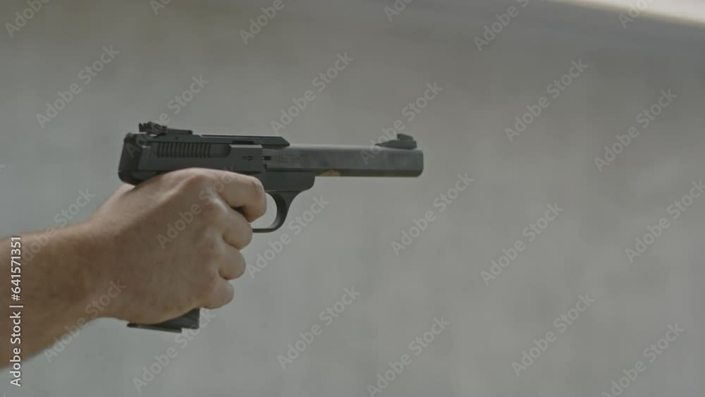 Shooter slowly and securely firing two shots and placing his finger ...