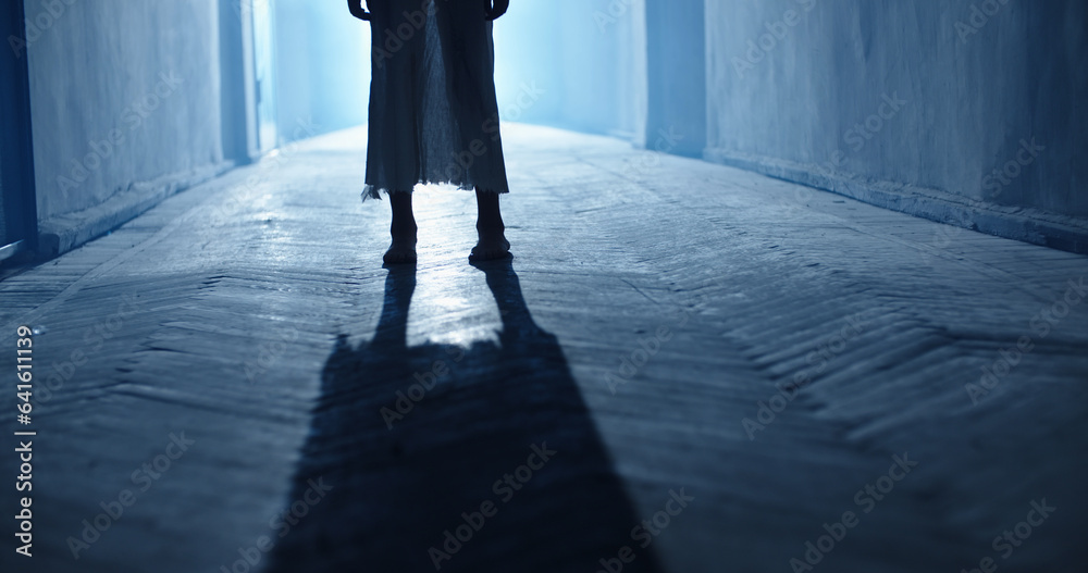 Low angle shot of legs of little girl ghost slowly creeping on floor of ...