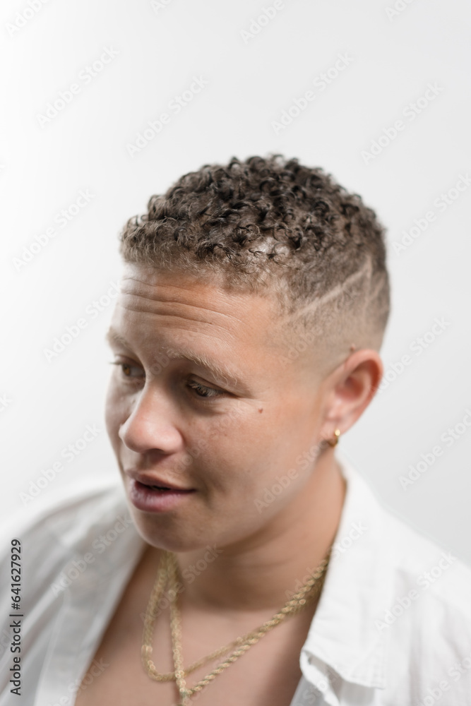 Candid portrait of a woman standing in a studio, against a white ...
