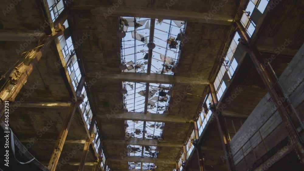 an industrial building with broken glass ceiling and destruction and ...