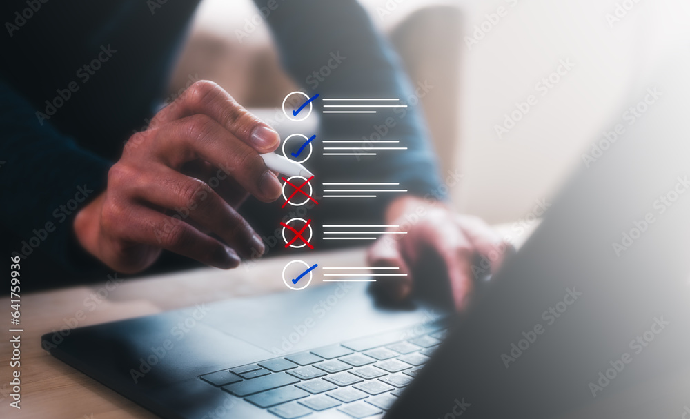 Businessman using pen to tick a mark in checkbox for quality document ...
