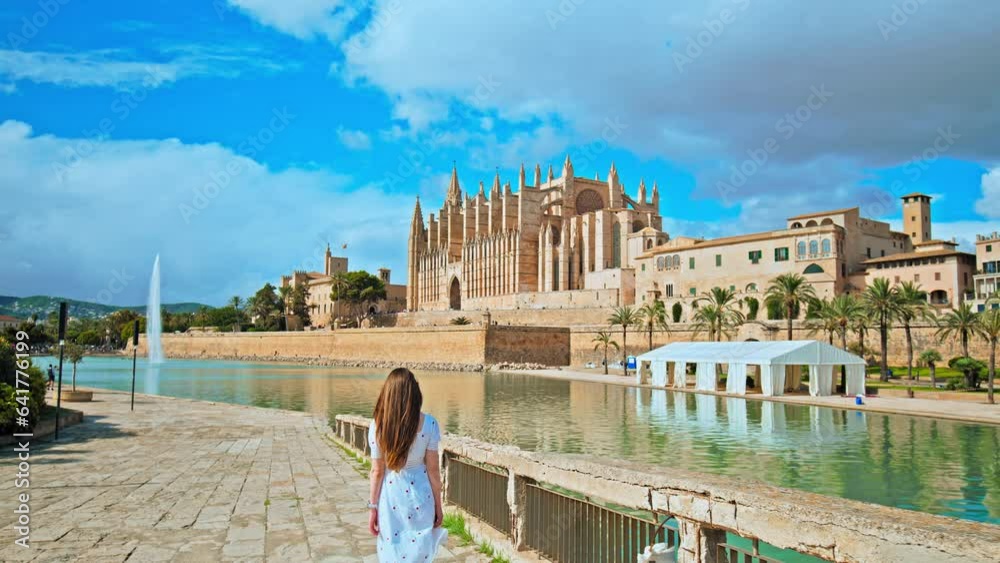 Beautiful girl tourist walking by iconic landmark in Palma Capital of ...