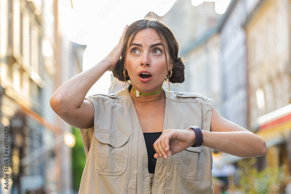 Confused woman worrying to be punctual, with anxiety checking time on ...
