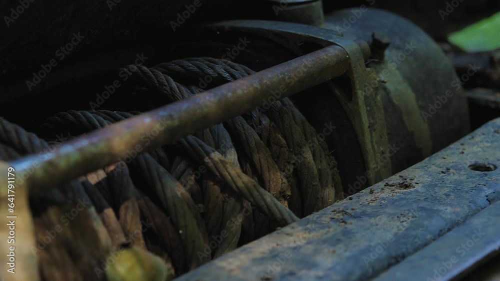 Car winch on SUV bumper with coiled steel cable. Old dirty winch with ...