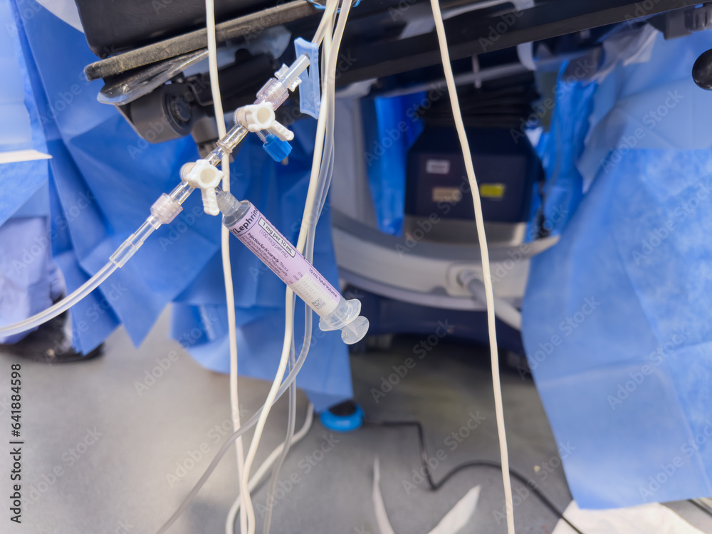 Medical supplies including syringes, IV drips, and drug vials symbolize ...
