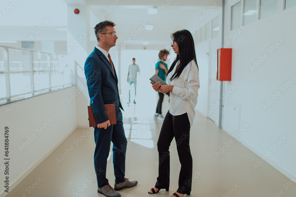 Business colleagues engage in a knowledge-sharing conversation during a ...