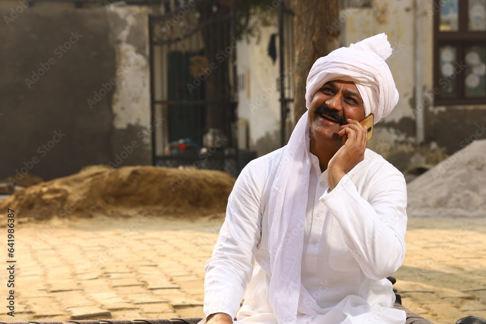 man sitting in Rural wearing kurta-pajama which is traditional Dress ...