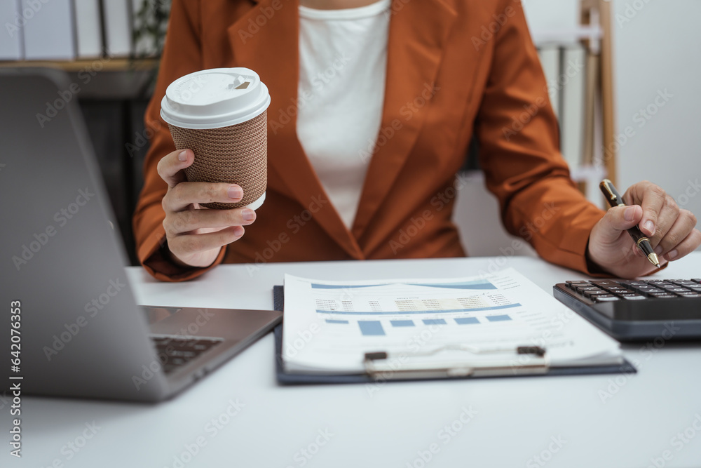Close up hands of woman in brown formal suit checking bills, taxes ...