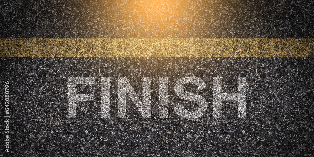 Foto de Textured asphalt with "Finish" text on the road under a yellow ...