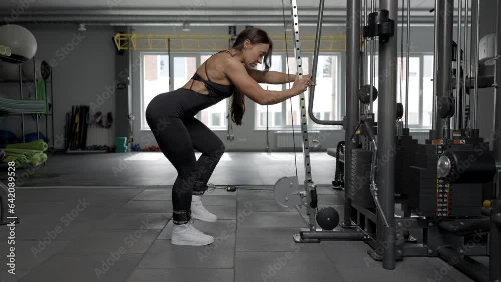 Strong fitness woman in black sportswear is training legs. Female with ...