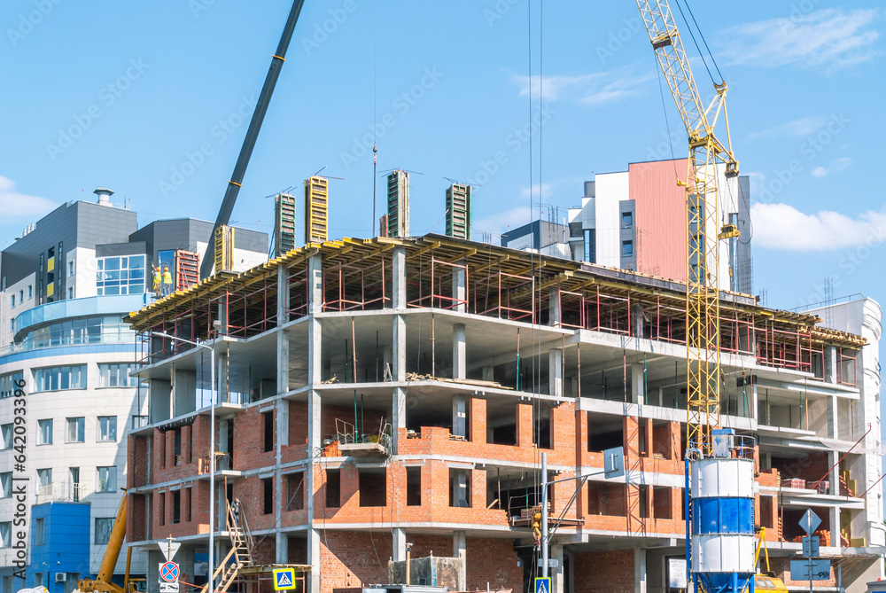 Installation of partitions and exterior walls made of red brick.The ...