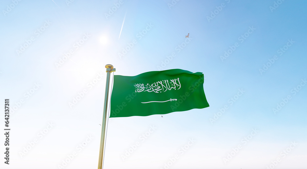 Flag of Saudi Arabia waving in the wind, sky and sun background. Saudi ...