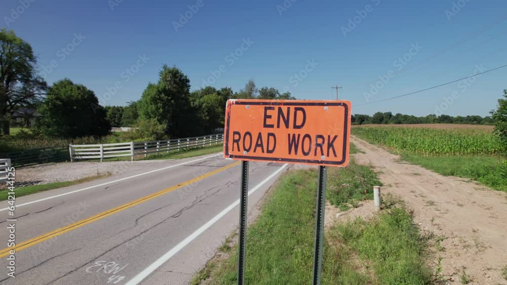 Rotating view of orange road sign label signaling with "End Road Work ...