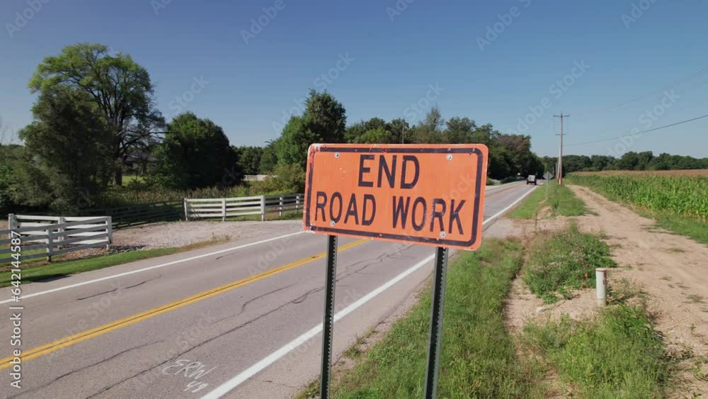 Rotating view of orange road sign label signaling with "End Road Work ...