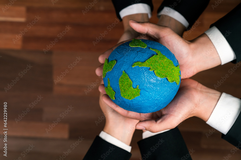 Top view business people holding Earth together in synergy as team ...