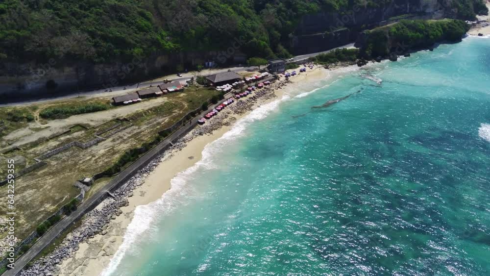 Pandawa Beach in Bali features a beautiful blue sea with the gentle ...
