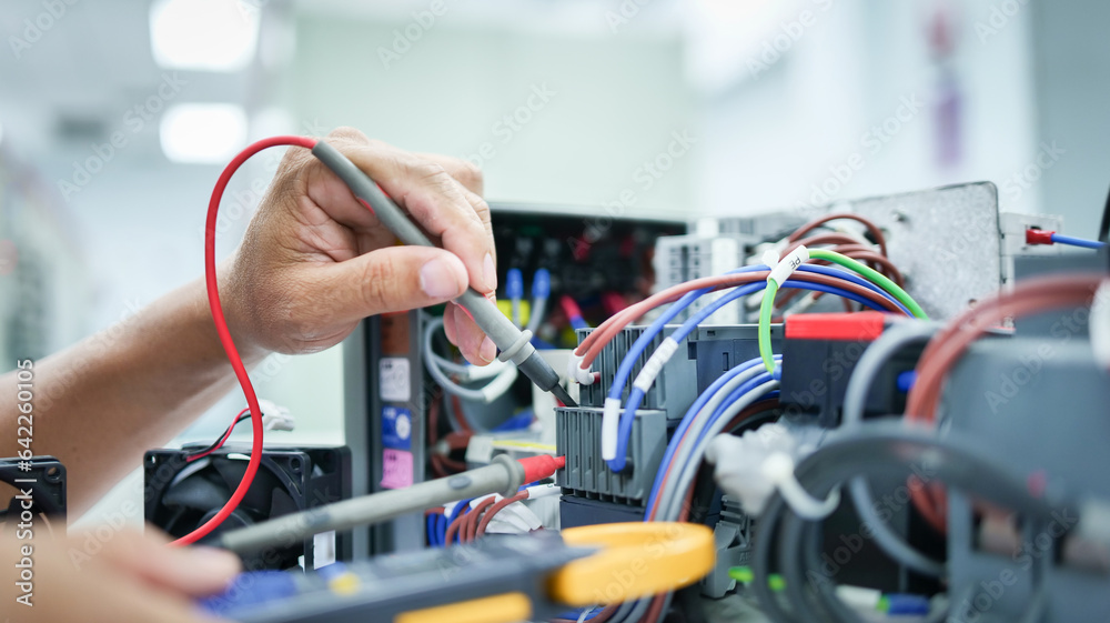 Electrical engineer checking and fixing automatic control switchboard ...