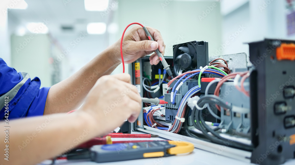 Electrical engineer checking and fixing automatic control switchboard ...