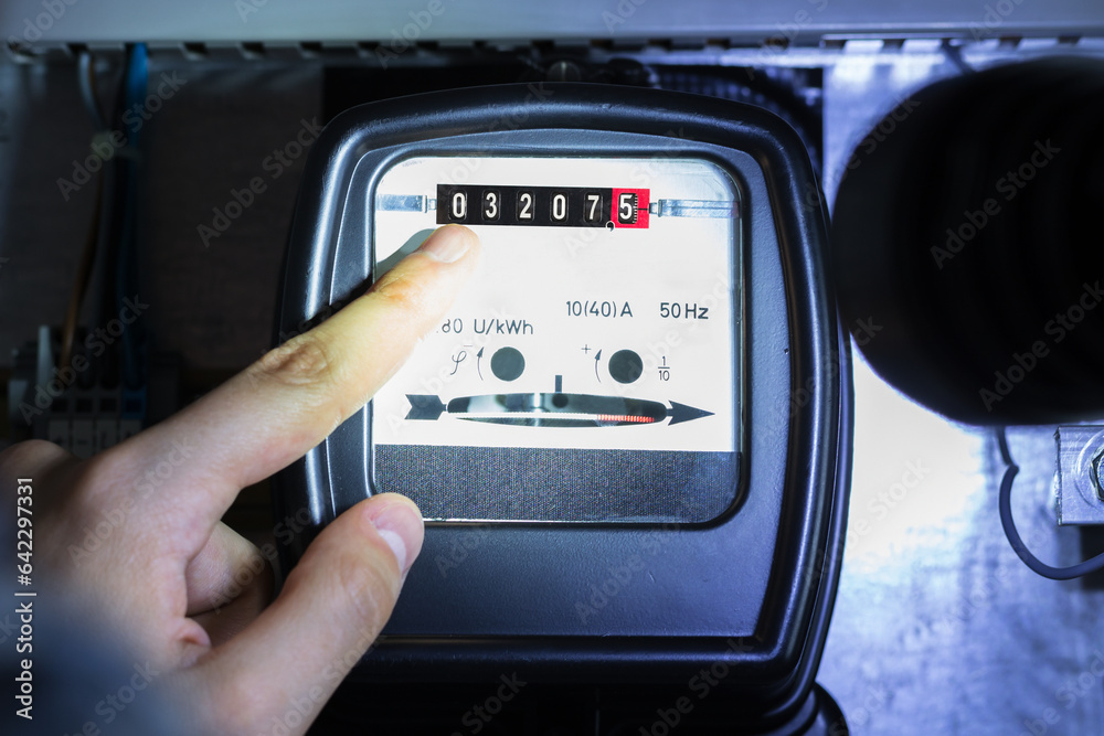 Finger Pointing To Electric Meter Reading Stock Photo | Adobe Stock