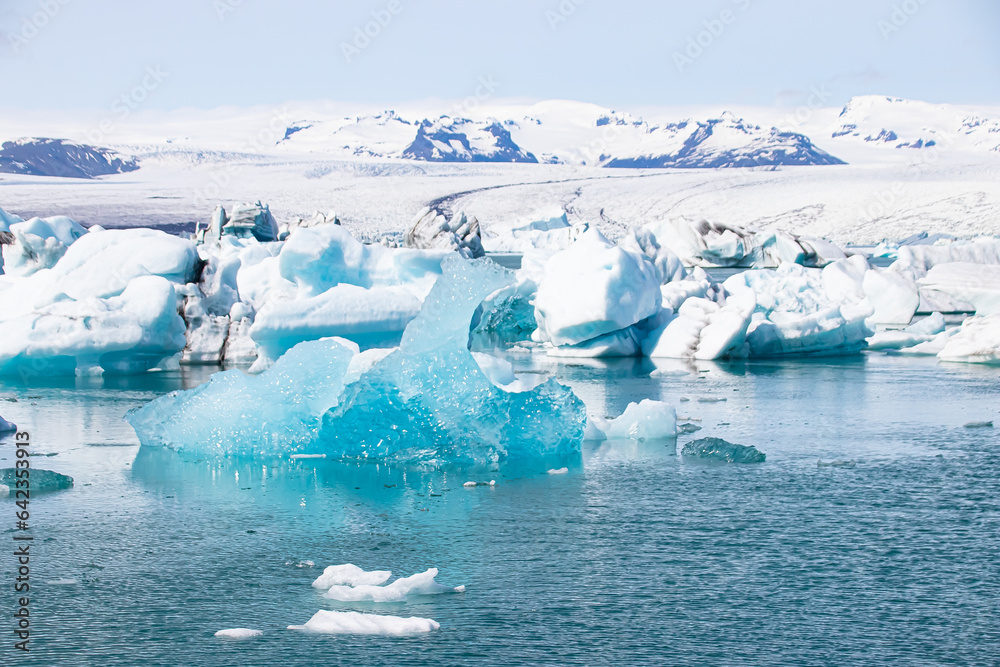 Ice floes in a glacial lake in Iceland with vulcano mountains in the ...