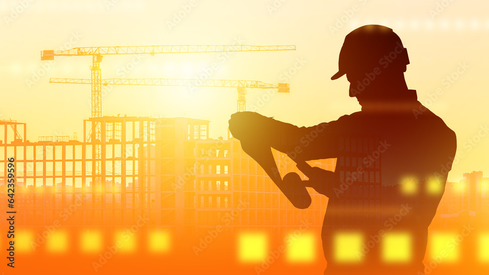 Builder at sunset. Silhouette of male architect. Construction of multi ...