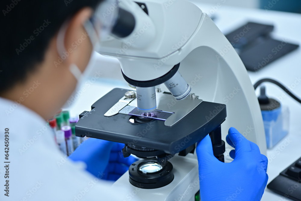 Medical Science Laboratory: Portrait of a scientist looking under a ...