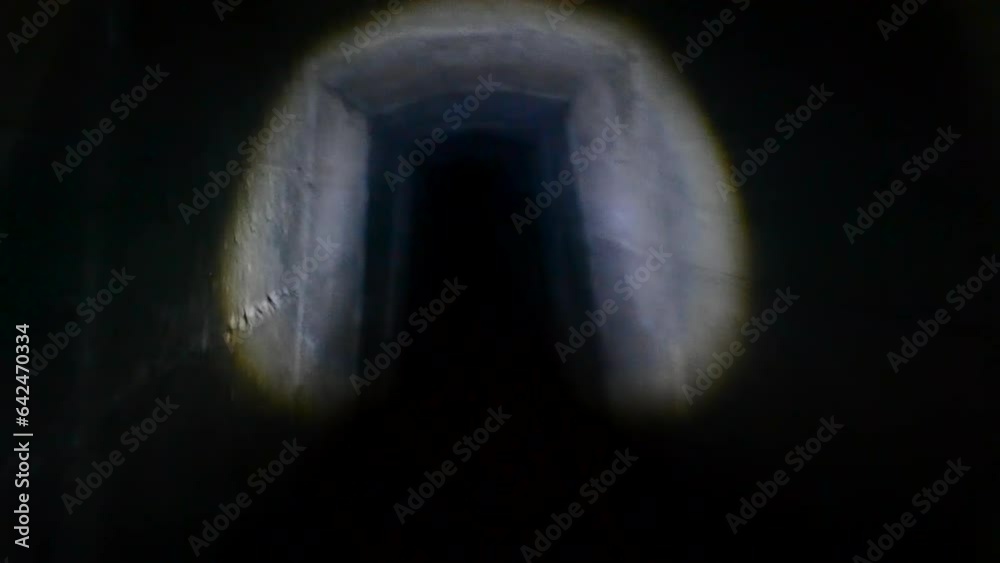 Digger person walking through dark tunnel adit, rain collector, sewer ...