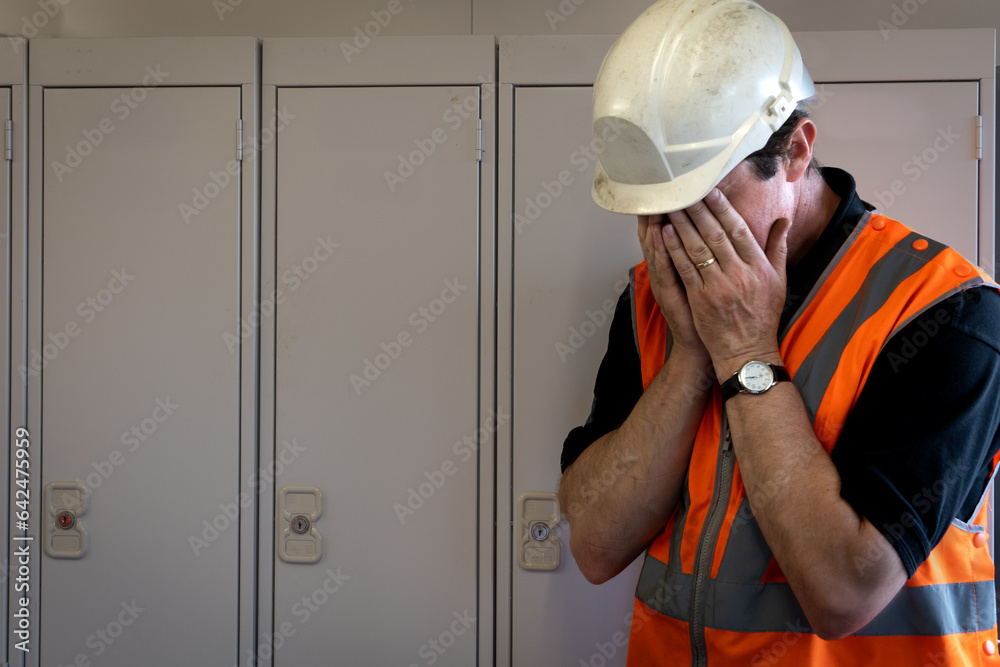 Male industry worker struggling to cope with mental health at work ...