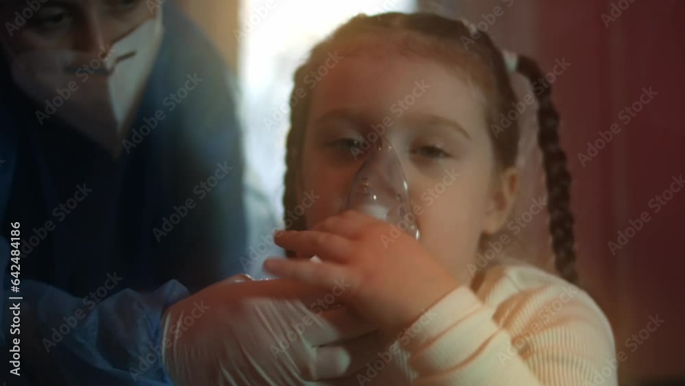 Beautiful little girl makes inhalation using a compressor inhaler at ...