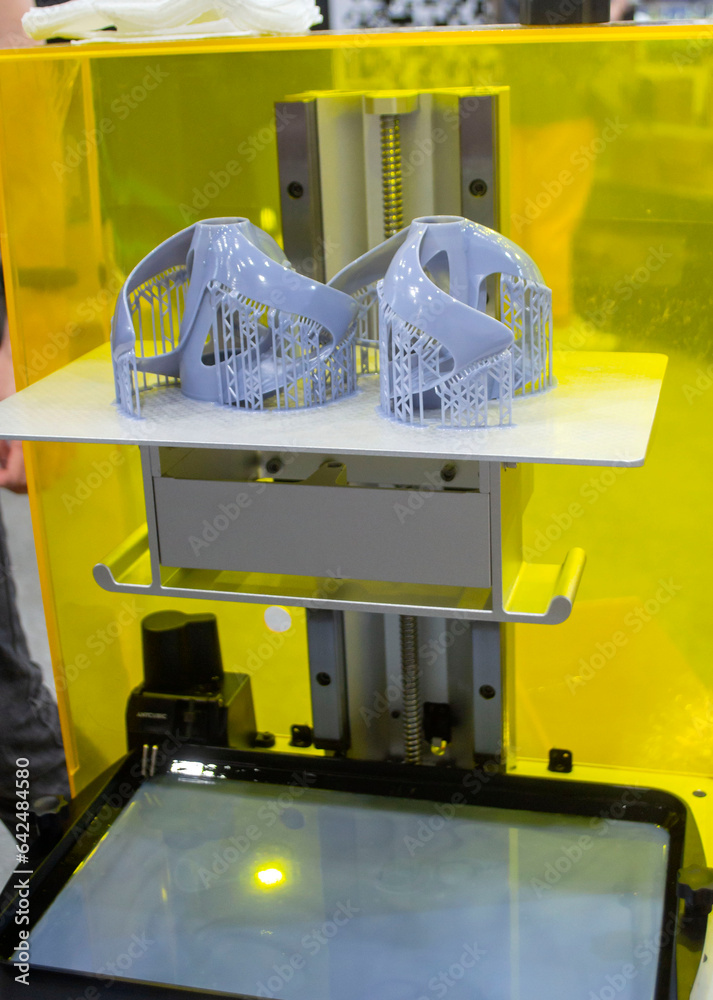 Printed models on 3D printer close-up. Objects printed on photopolymer ...