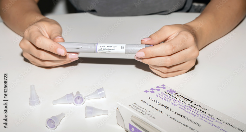 Female hands holding an insulin pen. Lantus Insulin injection pen ...