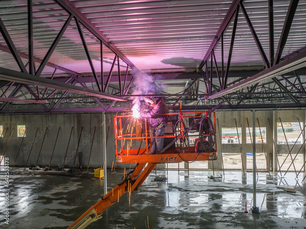 construction worker welding steel roof trusses Stock Photo | Adobe Stock