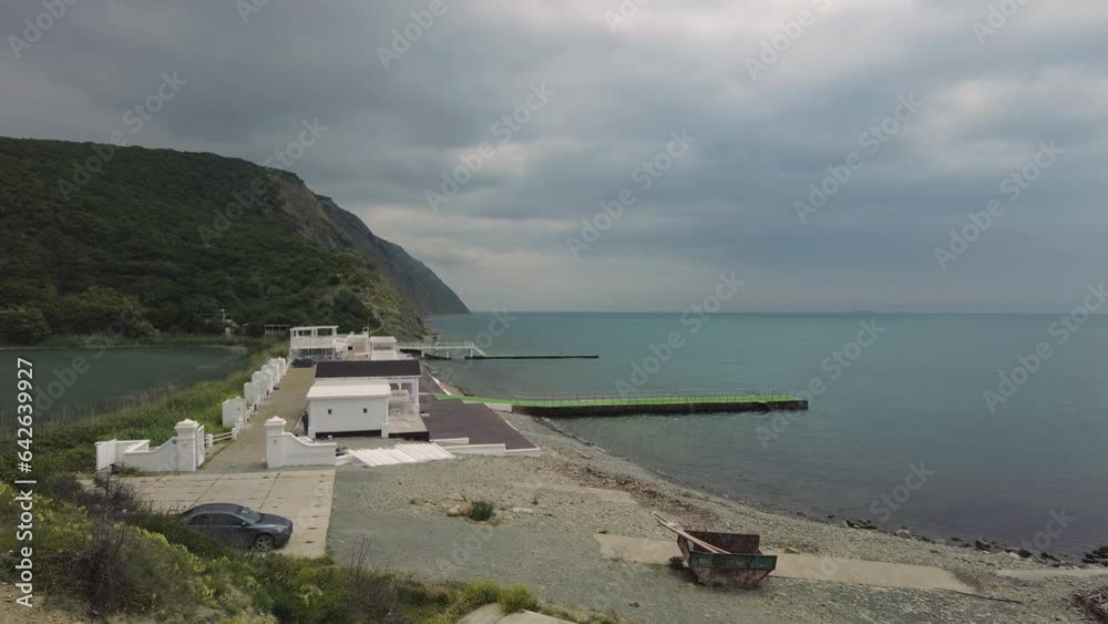 Stone embankment with a pier extending into the Black Sea. Russia ...