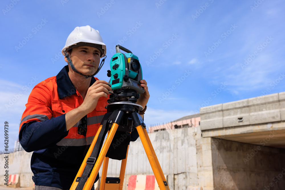 engineer use theodolite equipment for route surveying to build a bridge ...