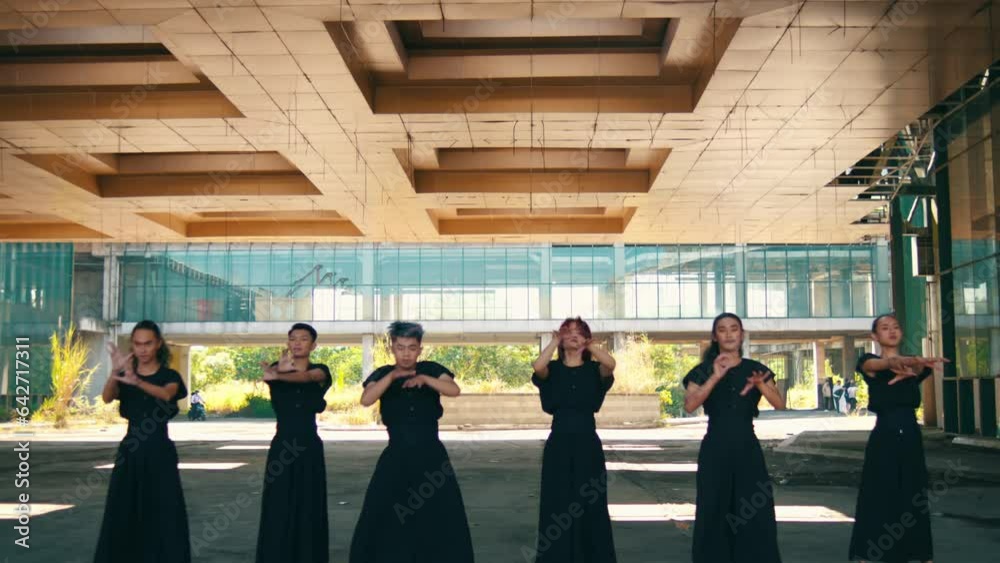 a group of Asian men in black clothes dancing with their hands and full ...
