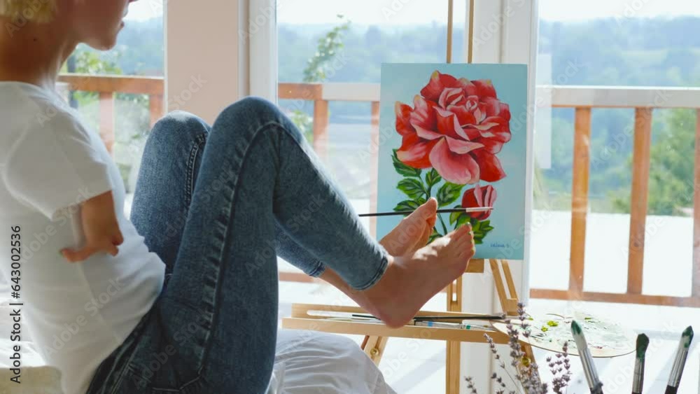 Adult girl with Phocomelia syndrome picking up a paintbrush with her ...