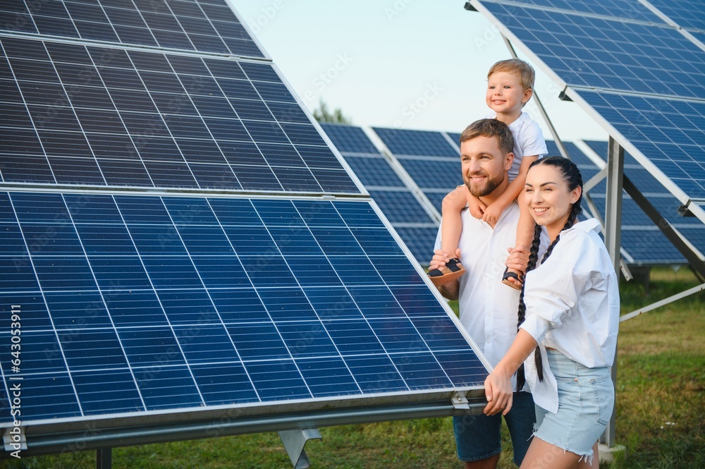 The concept of green energy. Happy family walking and having fun in ...
