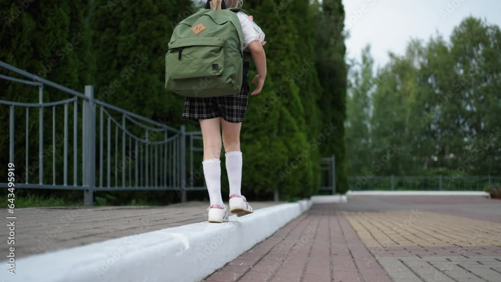Little Schoolgirl Walking On Curb, Keeping Balance, Back View, Closeup ...