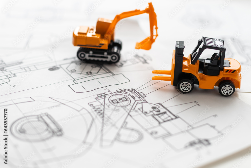 Toy construction machine builds model of house at the drawings. Stock ...