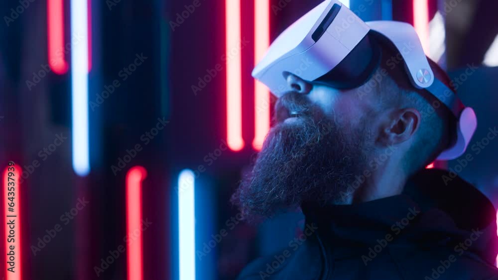 Man in futuristic costume. Guy in glasses of virtual reality while ...