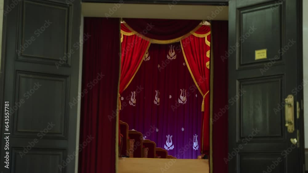 Open wooden doors in front of entrance to auditorium of theater. View ...