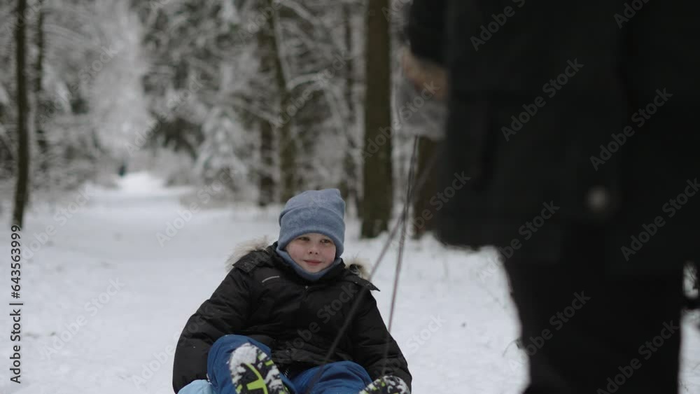 Portrait of happy boy waving greeting with his mittened hand and ...