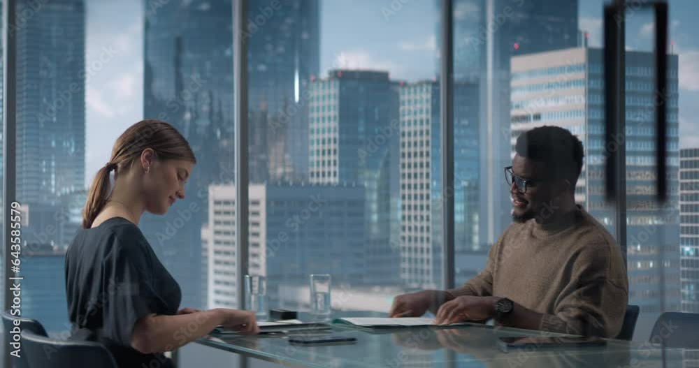Female and Male Business Partners Sign Successful Deal, Shake Hands in ...