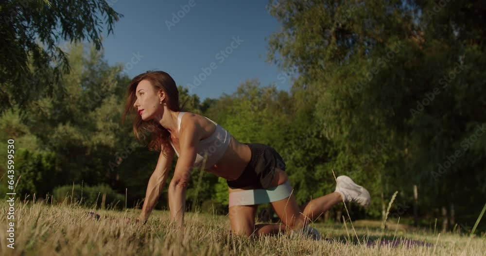 Active woman has workout outdoors, training buttocks muscles and doing ...