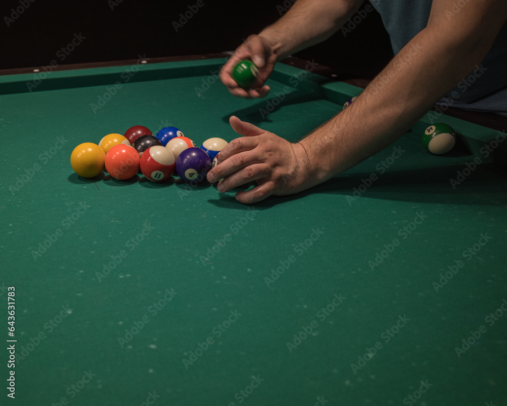 the player places the balls on the billiard table. a game of billiards ...