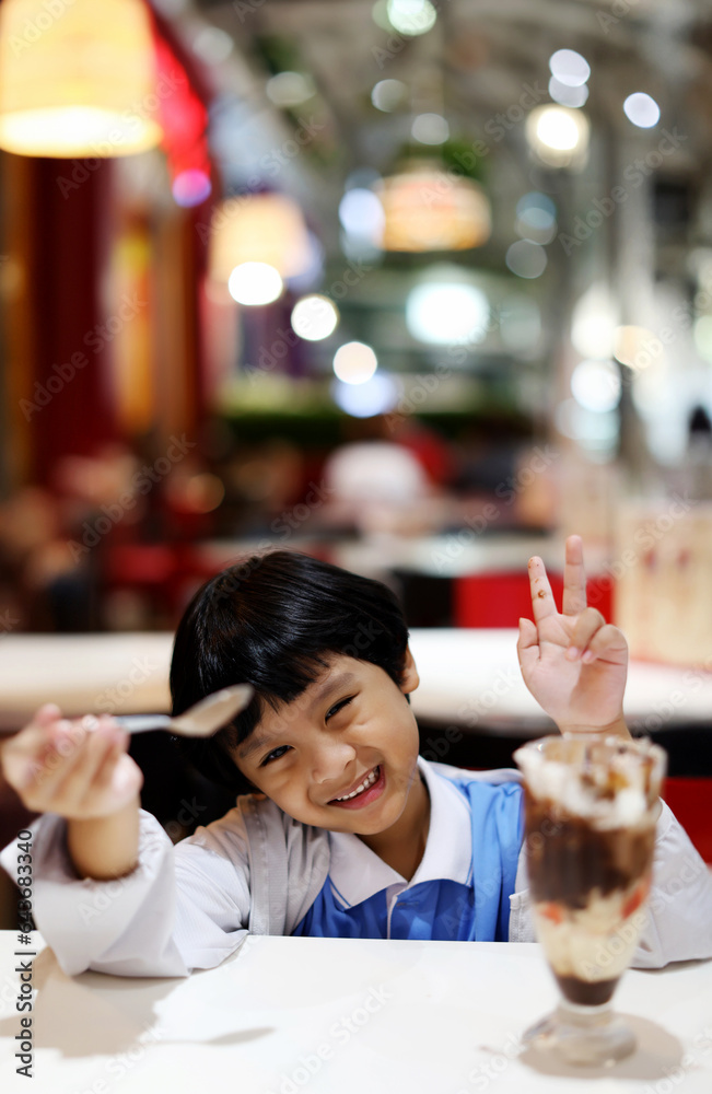 Happy child enjoy eating ice cream. Emotional kid demonstrating his ...
