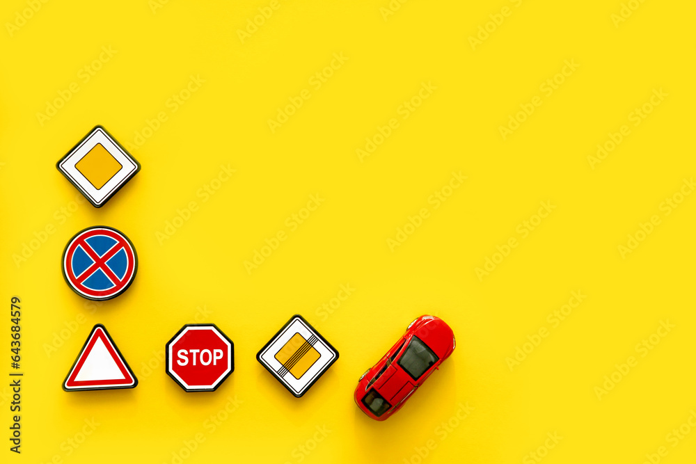 road signs with car on yellow background with copy space Stock Photo ...